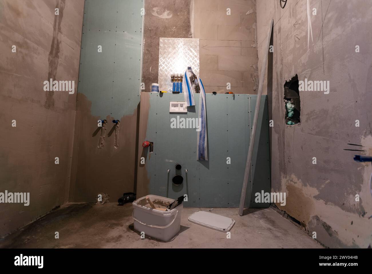 Installing gypsum plasterboard drywall for inside walls in new home is ...
