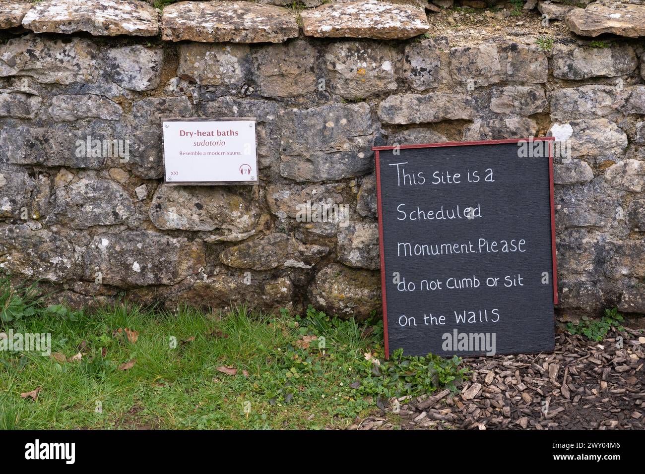 Sign requesting that visitors do not climb on walls as the site is a ...