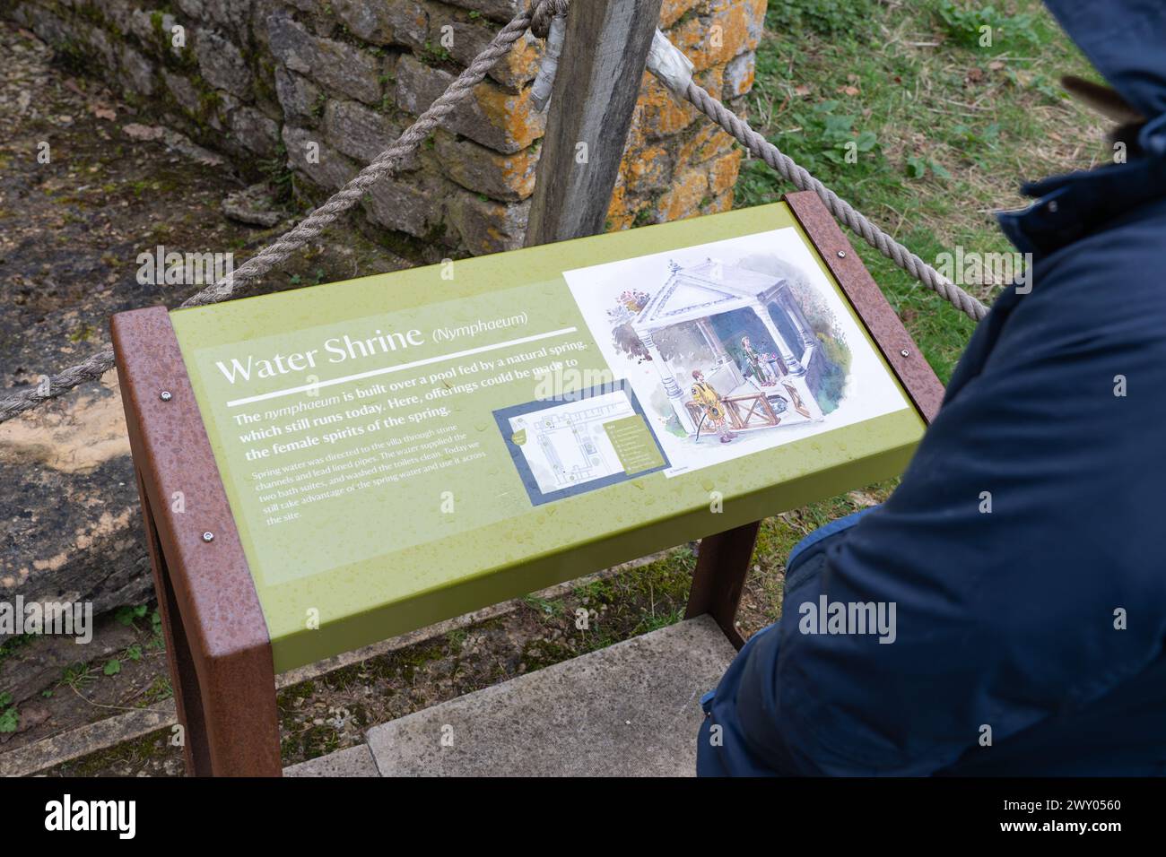 A tourist visiting the water shrine (Nymphaeum) at Chedworth Roman ...
