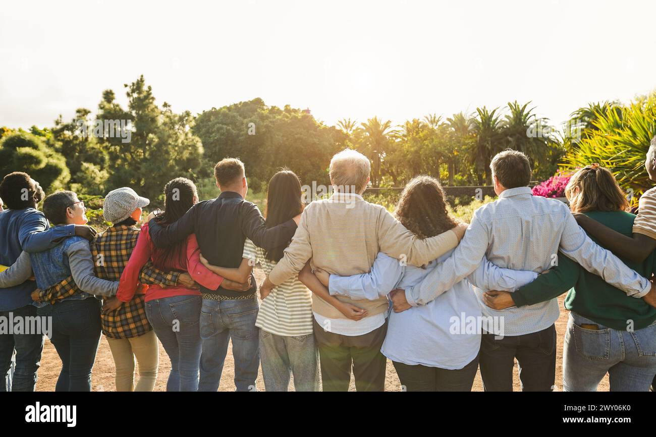 Group of multigenerational people hugging each others - Support ...