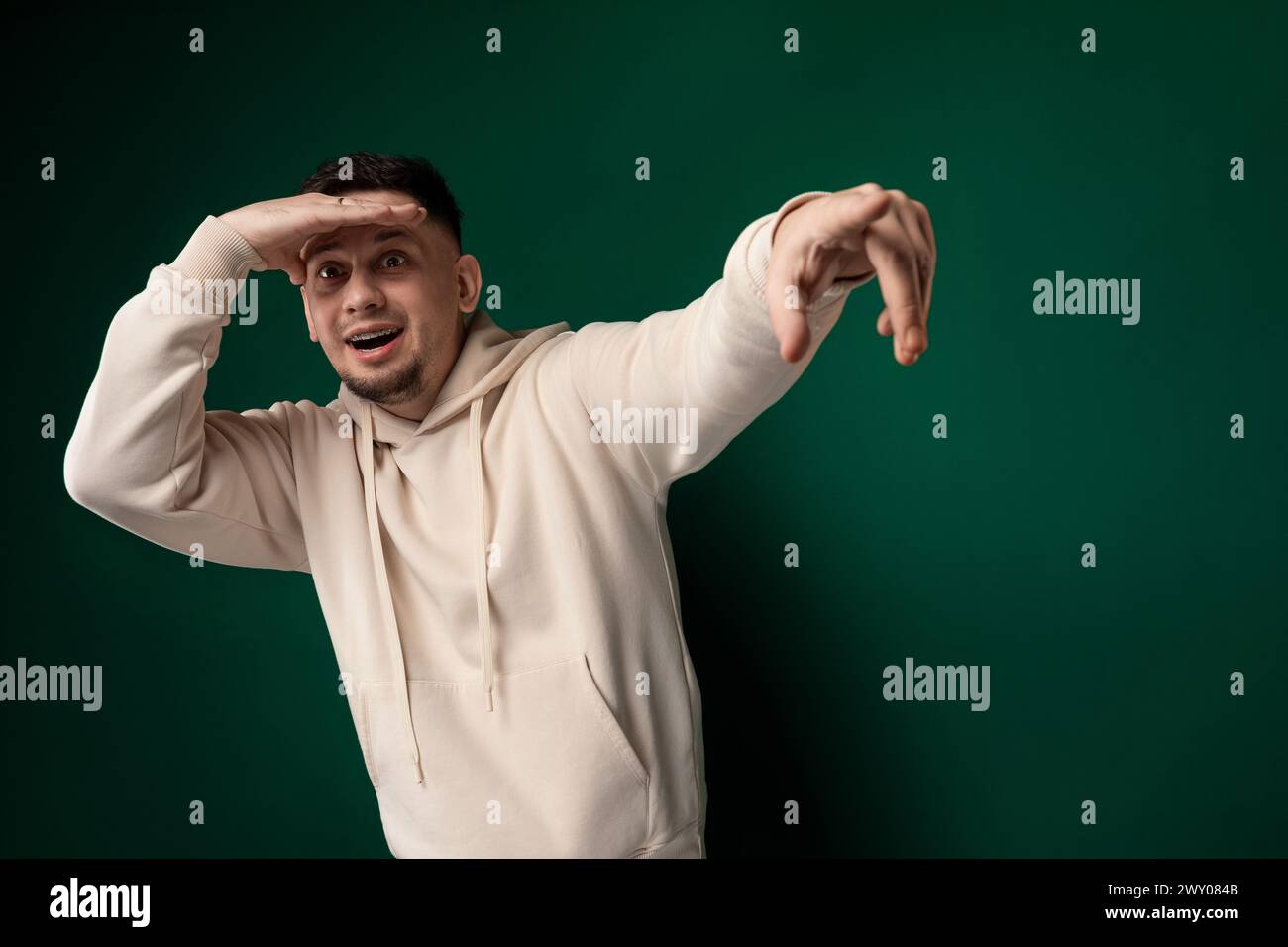 Man in Hoodie Holding Hands Behind His Head Stock Photo - Alamy