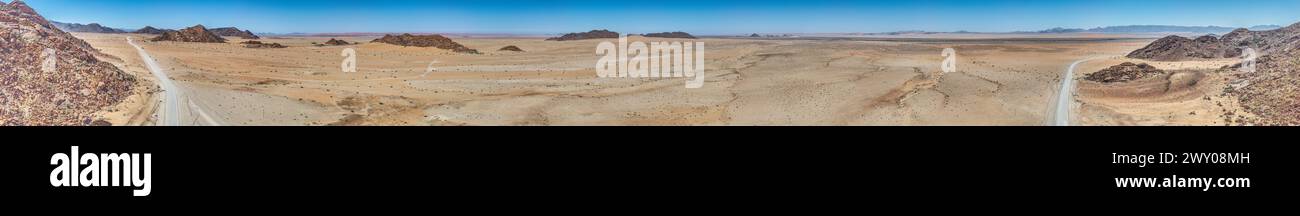 Panoramic drone picture of lonely gravel road through the desert on the ...
