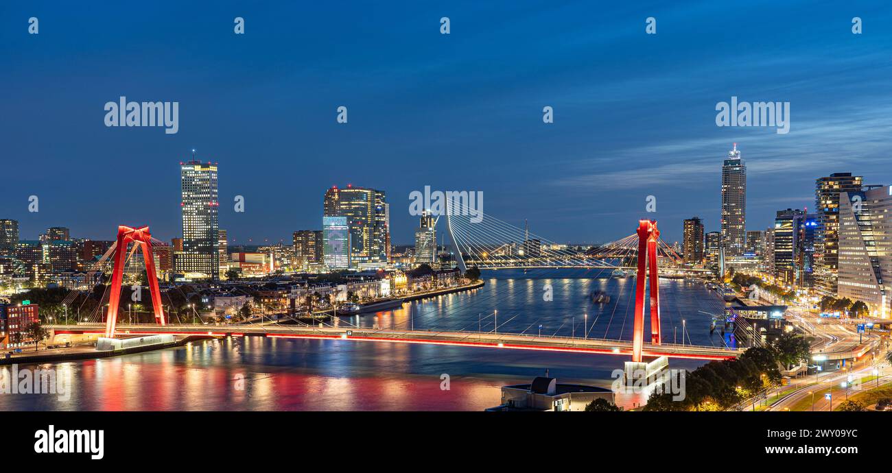 Sky line of Rotterdam at night over the river Maas showing the Willems ...