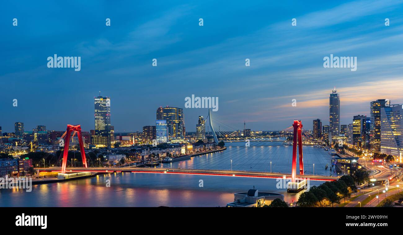 Sky line of Rotterdam at night over the river Maas showing the Willems ...