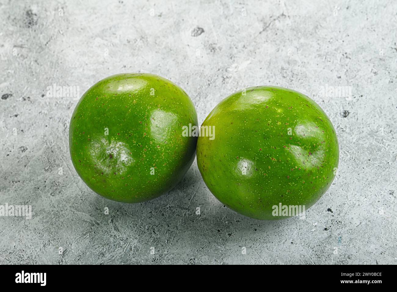 Two ripe green exotic avocado whole fruit Stock Photo - Alamy