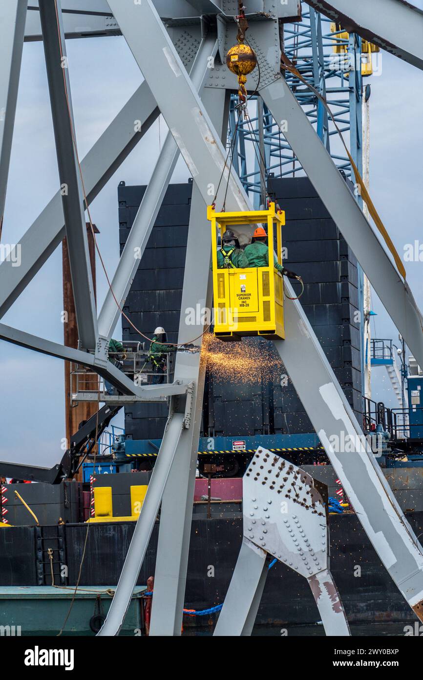 Highly trained salvage operations personnel use an exothermic torch to ...
