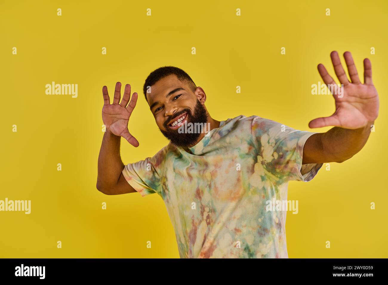 A man ecstatically raises his hands above his head, as if reaching out ...