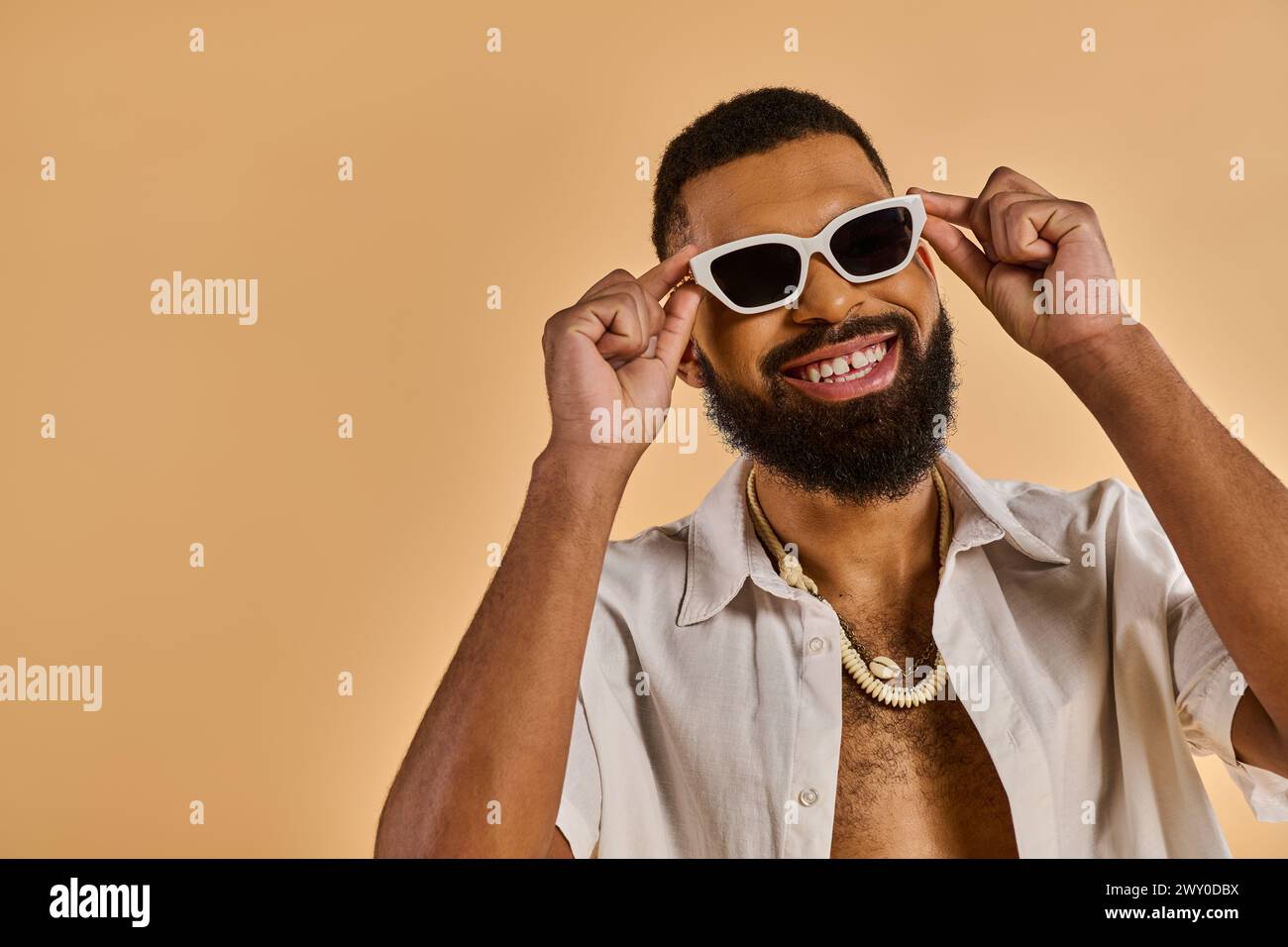 A man with a stylish beard and trendy sunglasses exudes confidence and ...