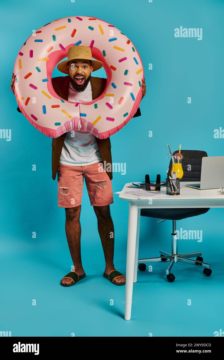 A man playfully holds a colossal donut in front of his face, creating a ...