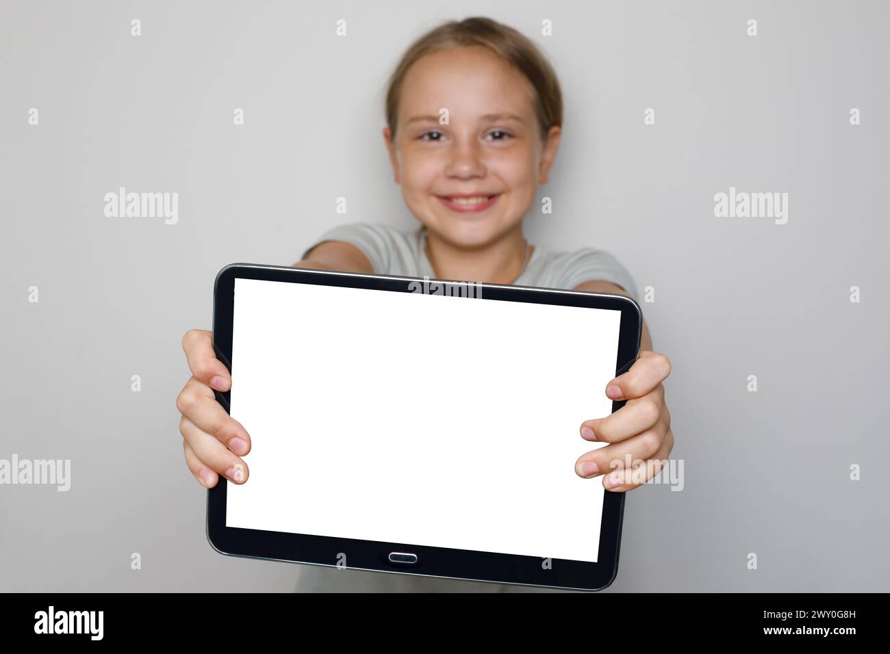 Blank empty tablet display in hands of beautiful cute child girl Stock ...