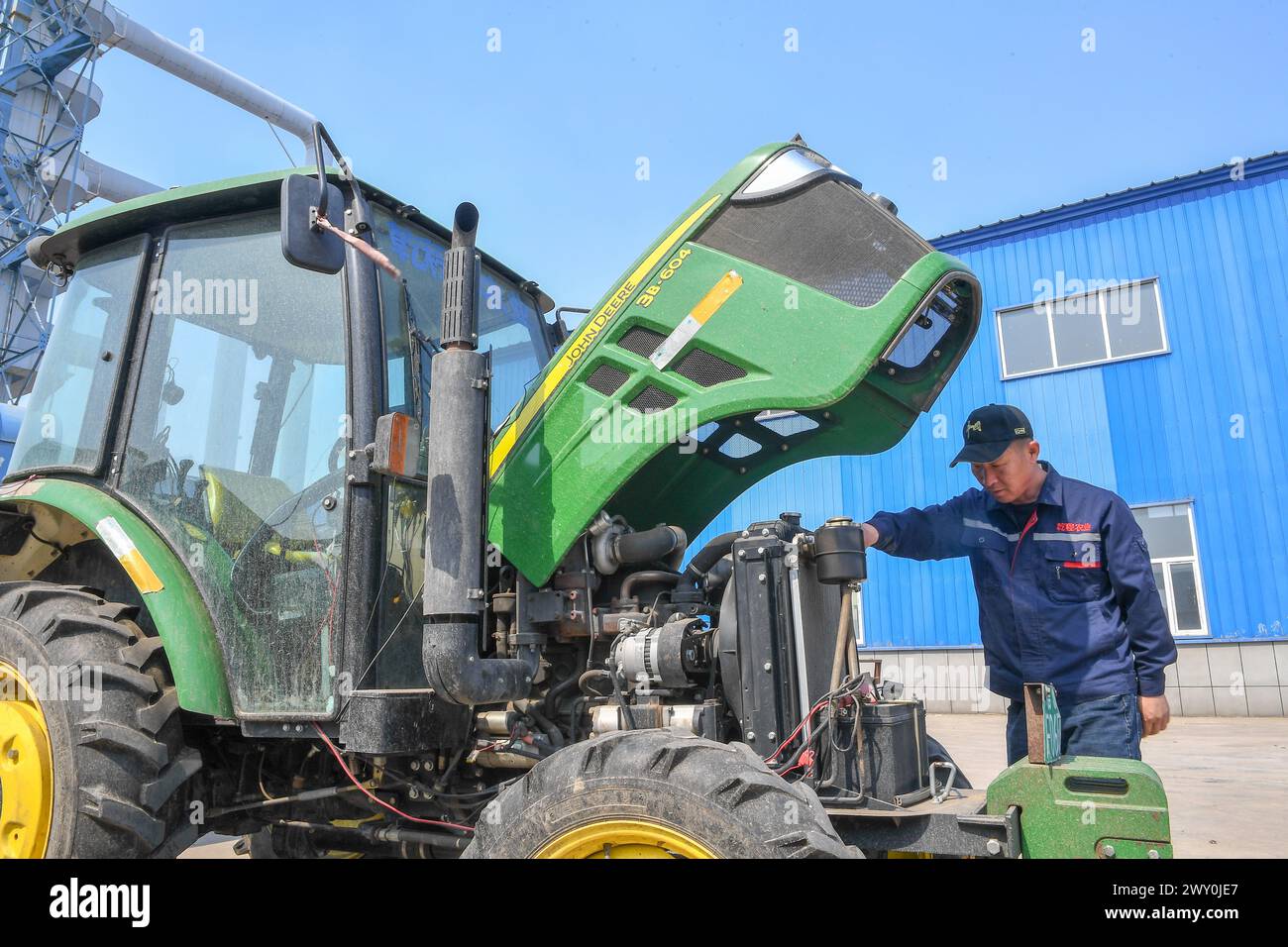 Changchun. 2nd Apr, 2024. A villager maintains an agricultural machine ...
