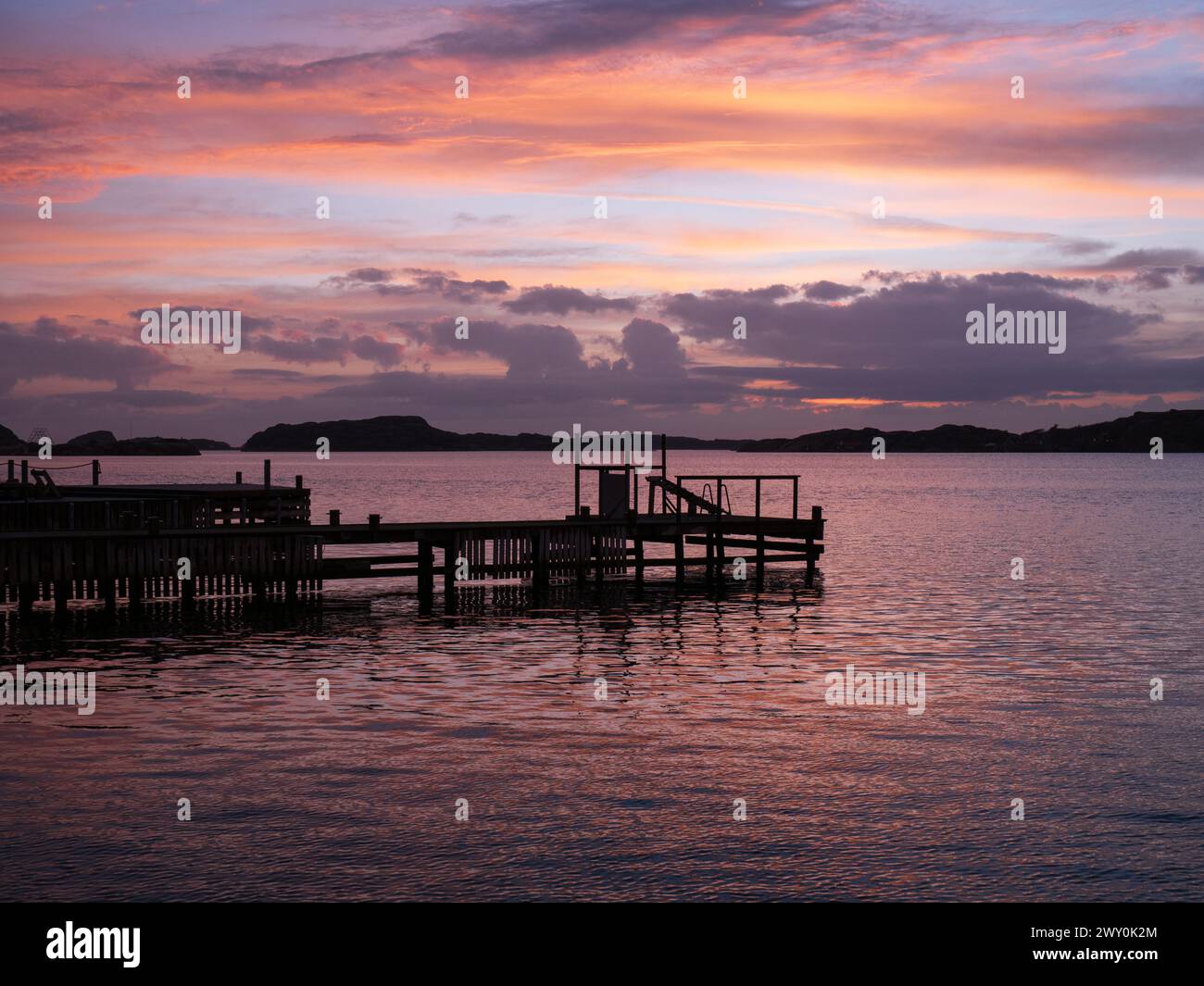 The sunset at tranquil bay dock with boats Stock Photo - Alamy