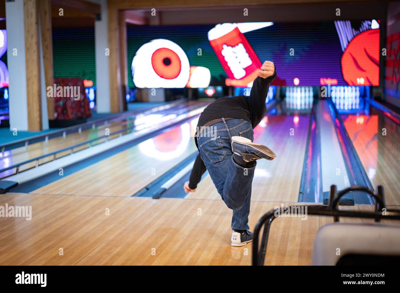 Rear view of a man throwing the bowling ball. Throwing with technique ...
