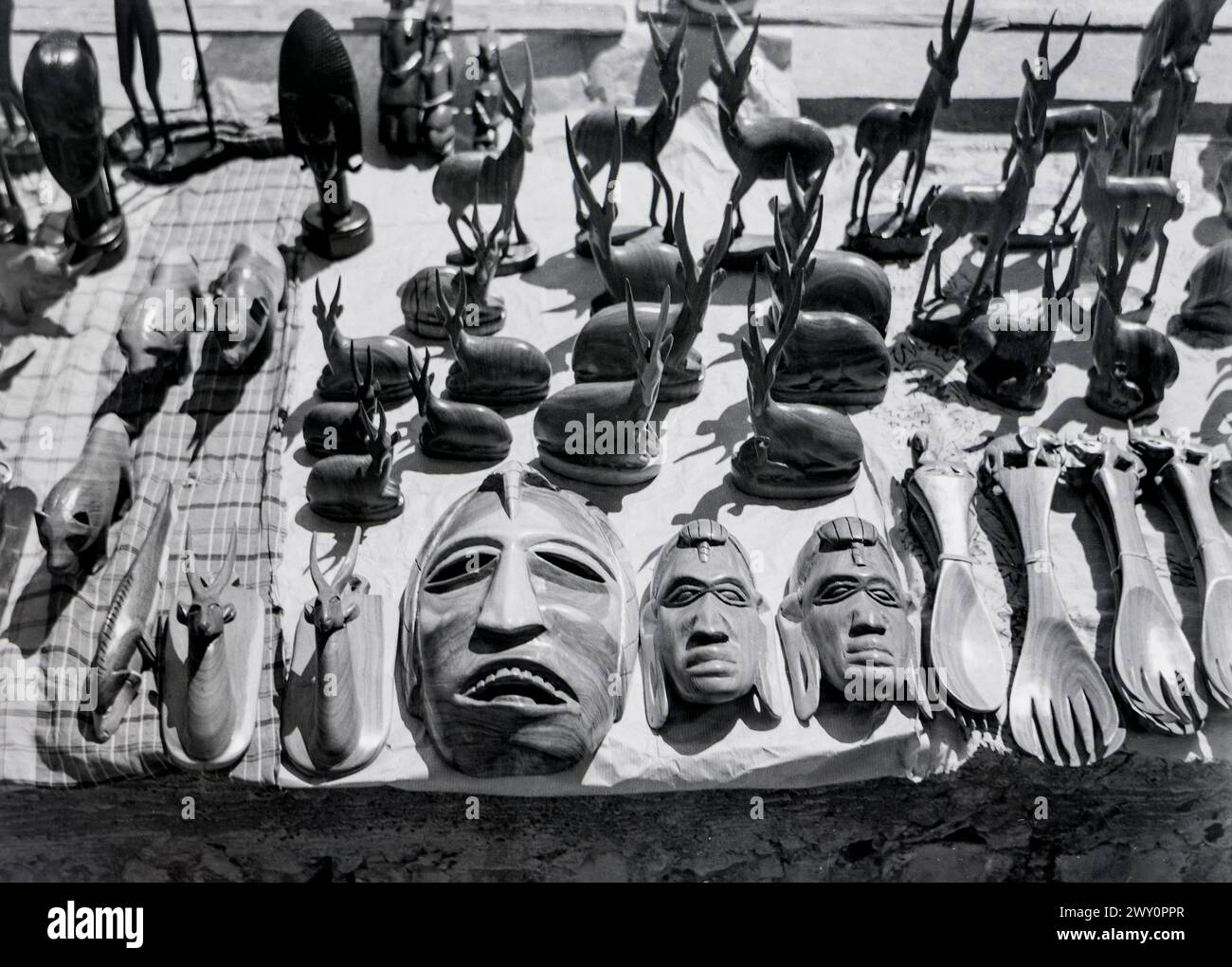 Souvenir stall selling carved wooden animals, masks and heads. Kenya ...