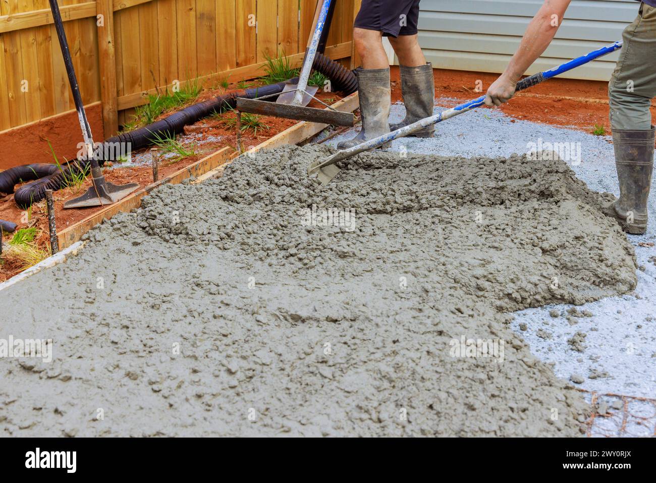 Leveling concrete by using special tool by construction worker Stock ...
