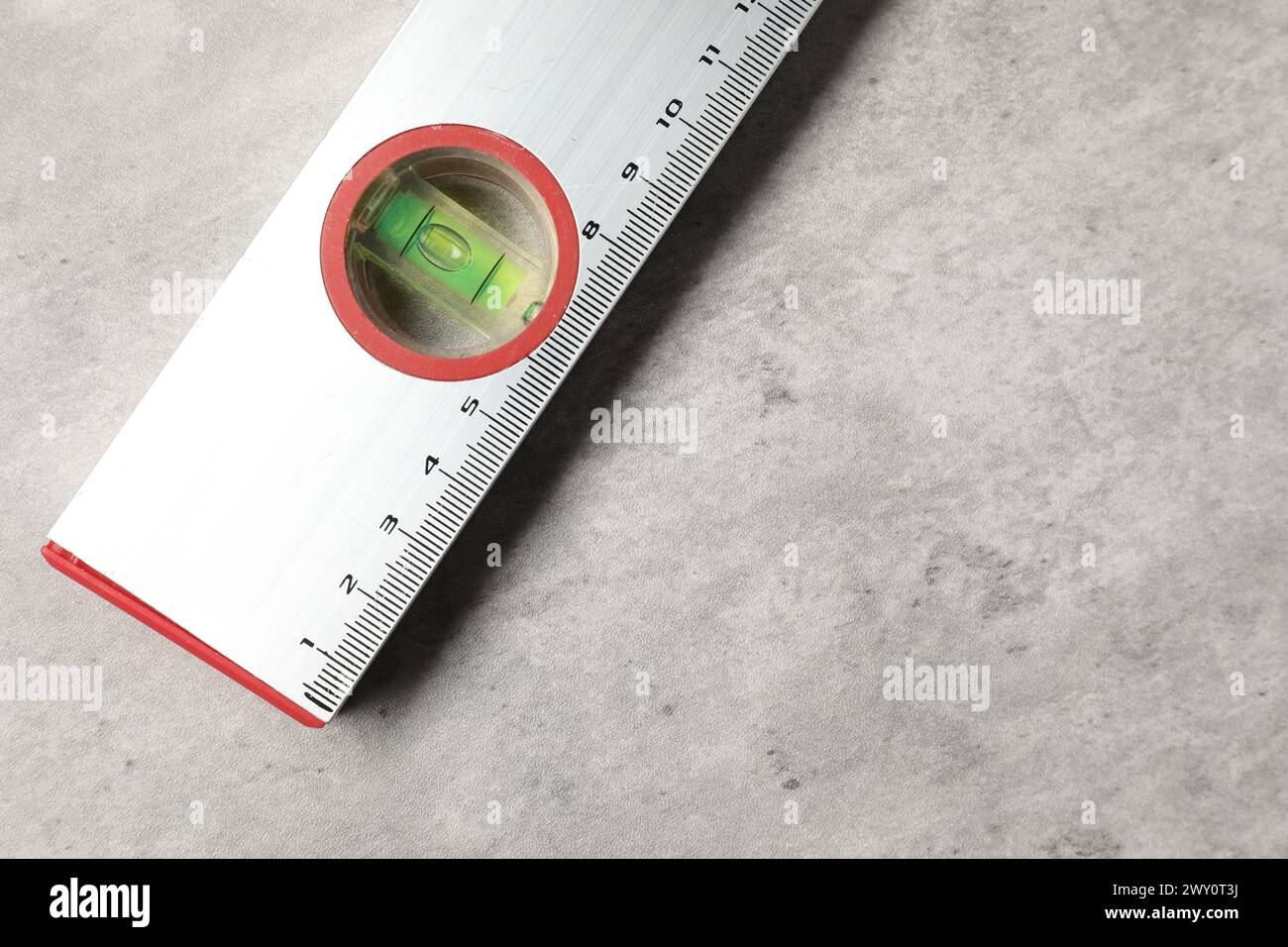 Aluminium building level on grey table, top view. Space for text Stock ...