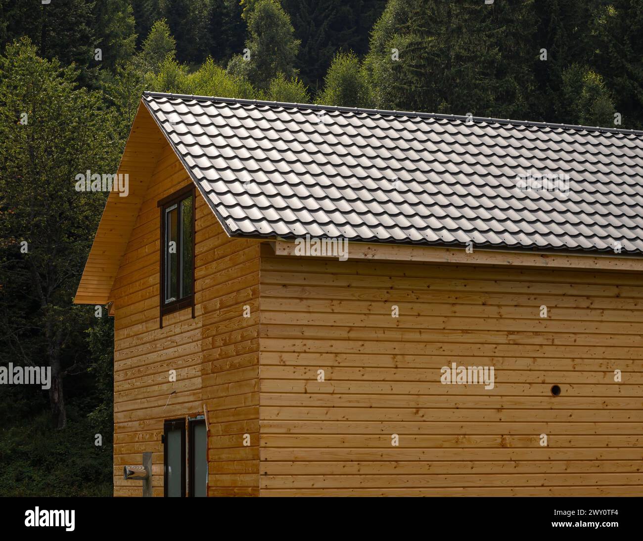 roof covered with metal tiles, roofing, wooden house Stock Photo - Alamy