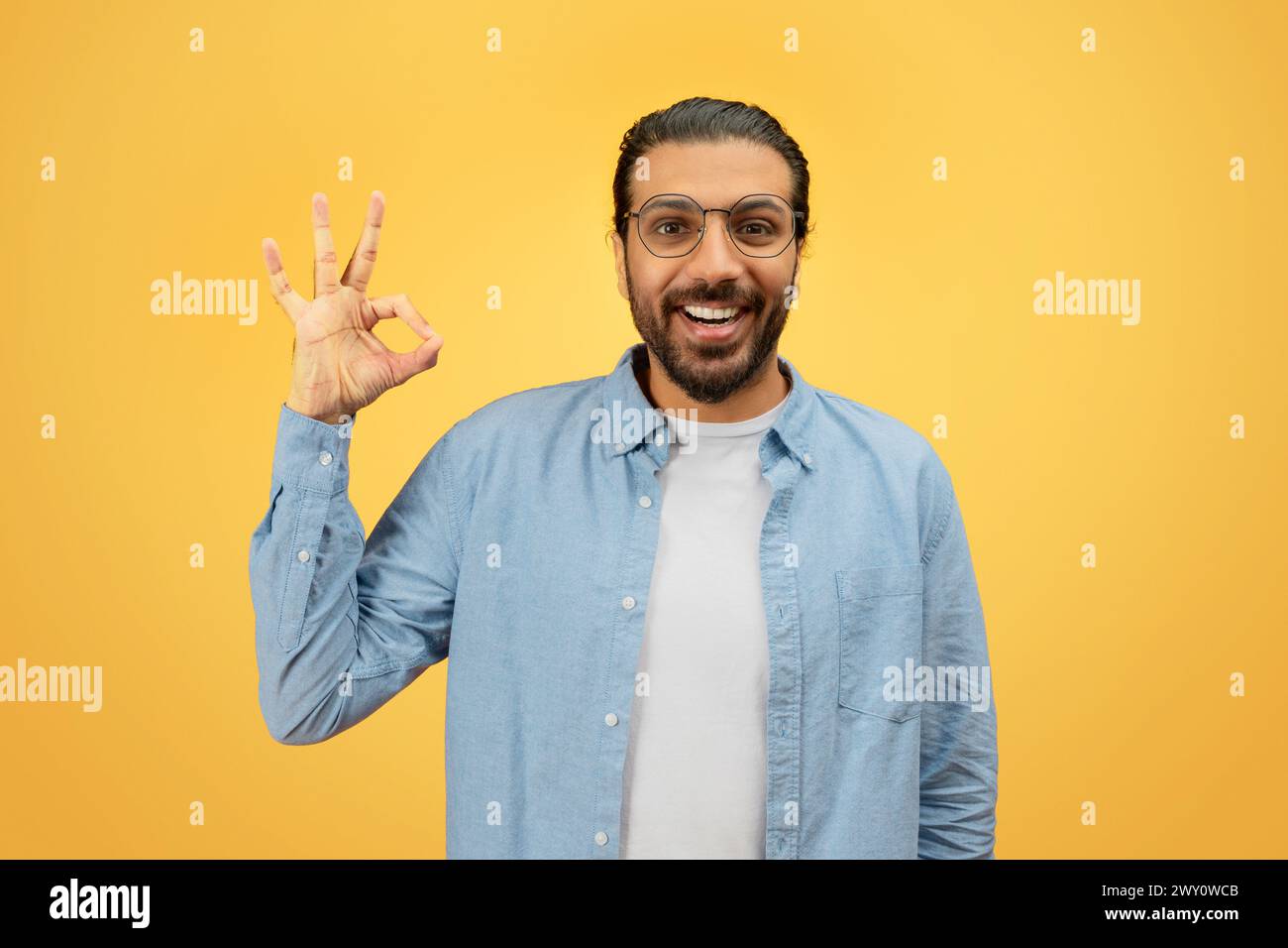 Man showing an 'OK' hand sign with a smile Stock Photo - Alamy