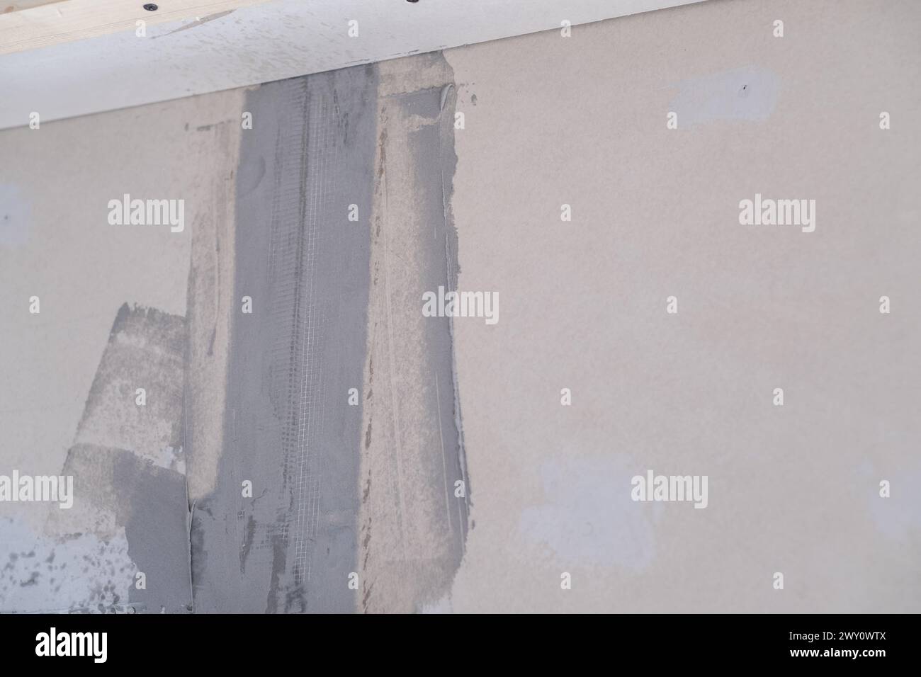 Applying decorative putty. White abstract texture of surface covered ...