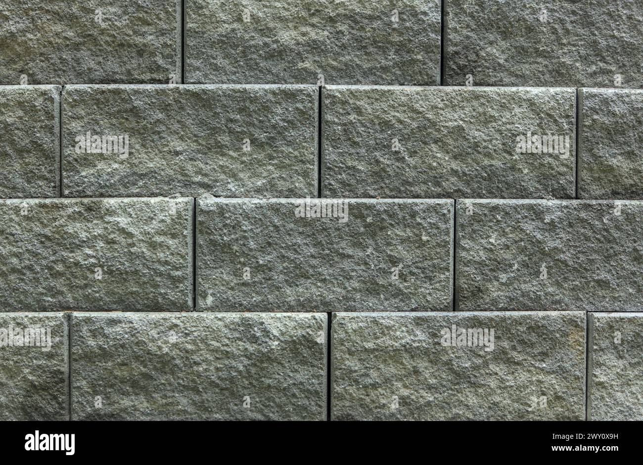 tall stone retaining wall (curved brick masonry) in house back yard ...