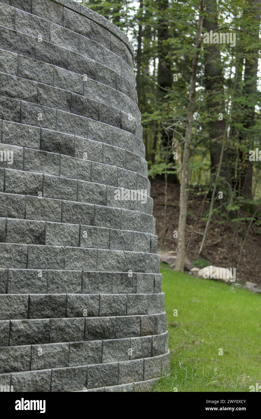 tall stone retaining wall (curved brick masonry) in house back yard ...
