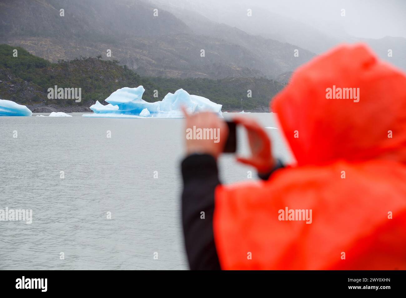 Tourists in the Grey III ferry take photos of icebergs while travelling ...