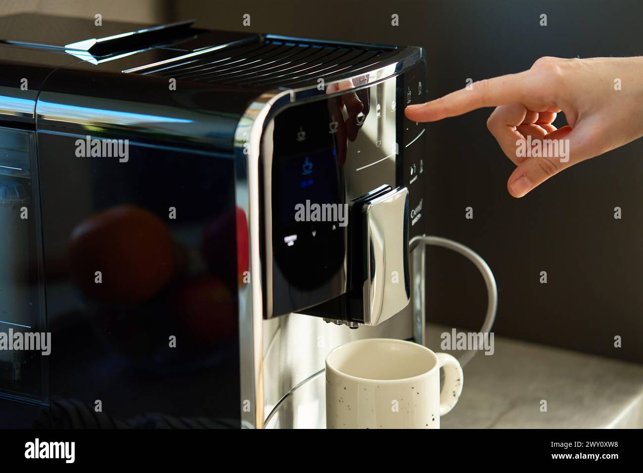 Woman preparing fresh cup of coffee with modern espresso machine ...