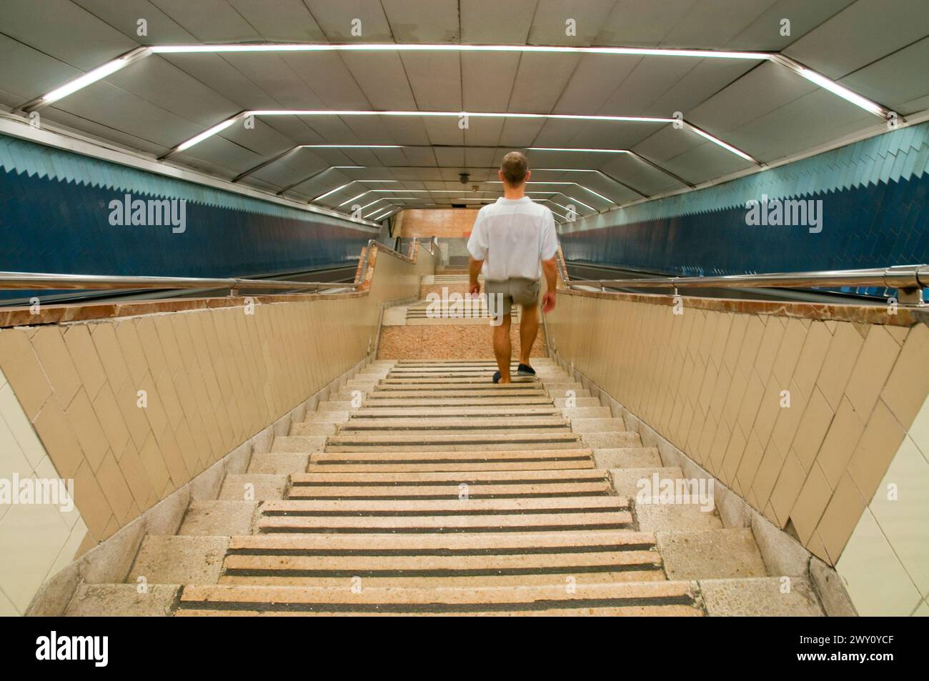 Man going downstairs Stock Photo - Alamy