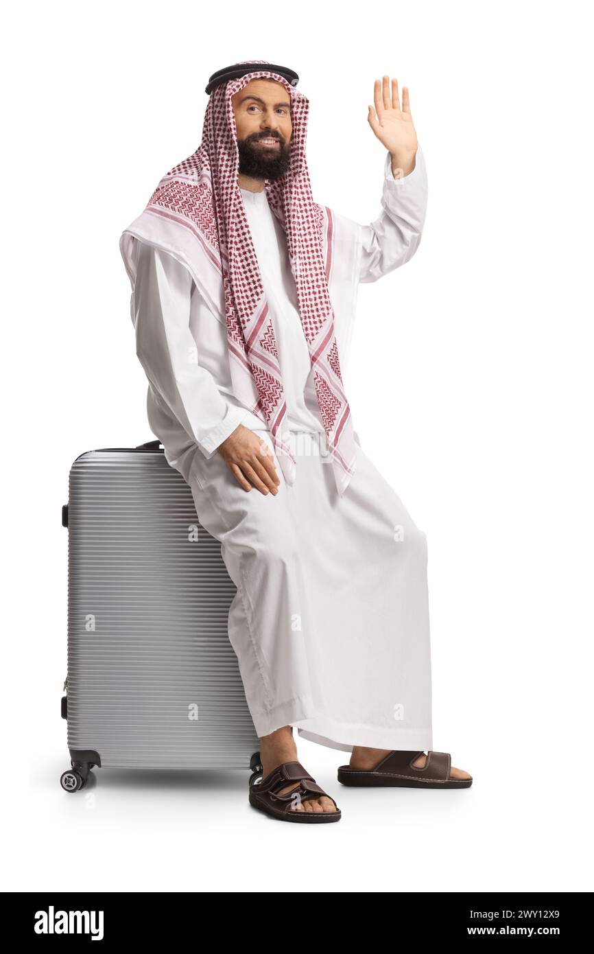 Saudi arab man sitting on a suitcase and waving isolated on white ...