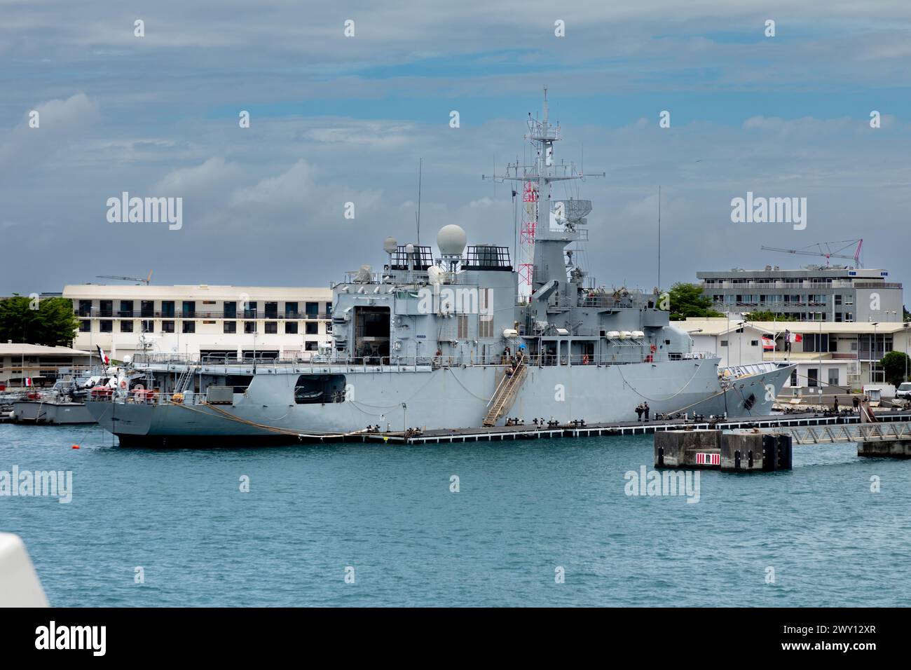 A French naval vessel is moored next to the main ferry terminal of ...