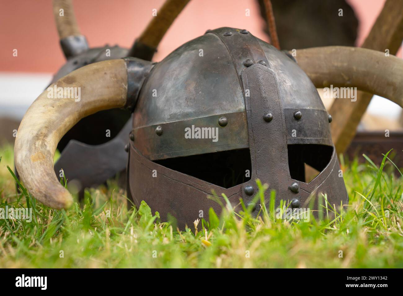 Medieval Viking wrought iron helmet with horns placed on the ground ...