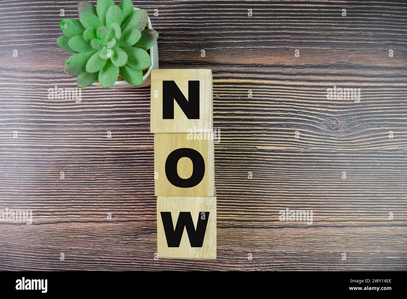 Concept of The wooden Cubes with the word NOW on wooden background ...