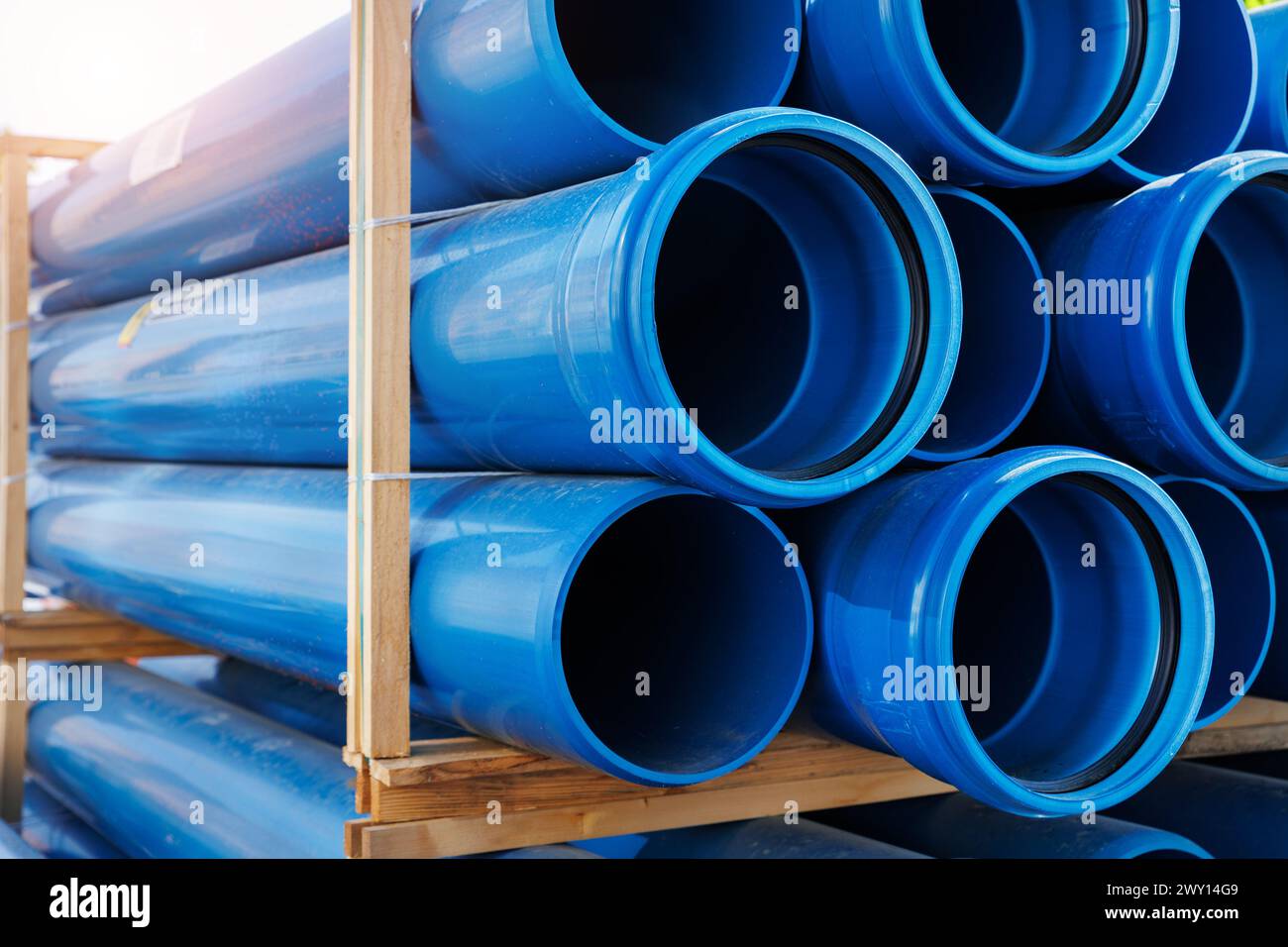 Close-up blue PVC plumbing pipes stacked wooden pallets replacement at ...