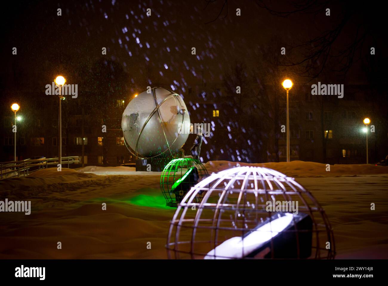 OBNINSK, RUSSIA - DECEMBER 2018: Falling snow over a white spotlight on ...