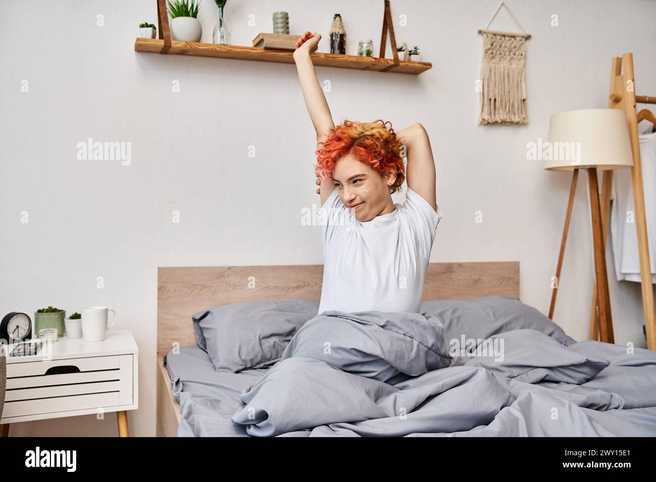 extravagant pretty queer person in casual attire waking up and ...