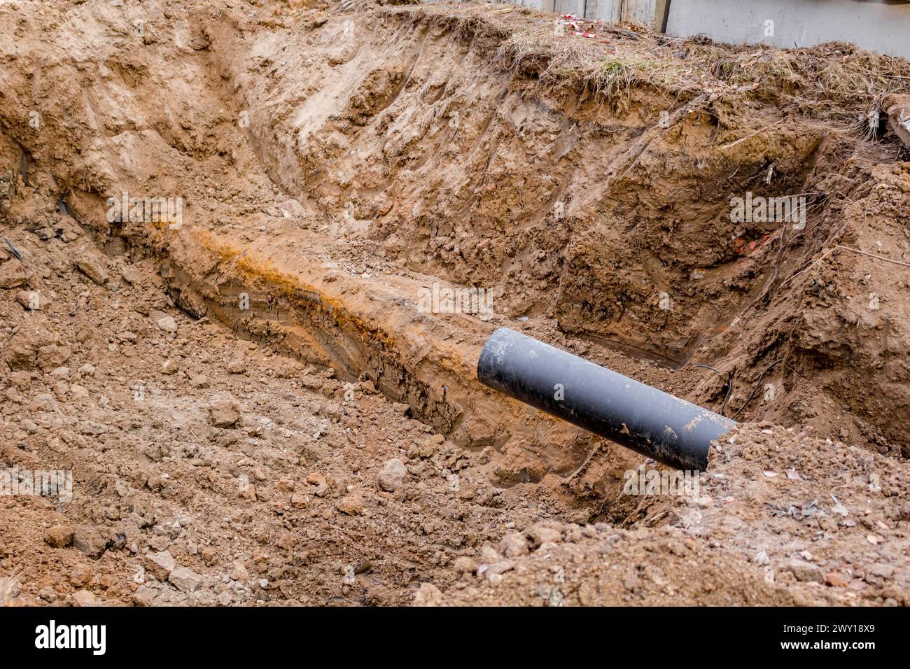 Pipe laying in the ground, laying communications Stock Photo - Alamy