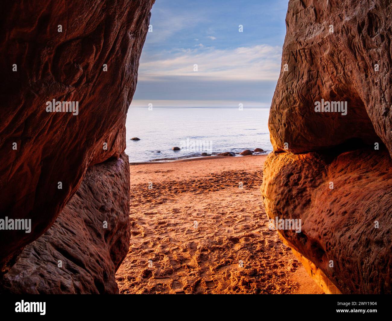 As daylight wanes, Veczemju Klintis Cave becomes a haven for sunset ...