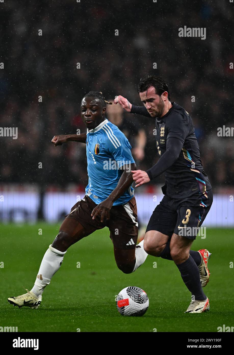 LONDON, ENGLAND - MARCH 26: Jeremy Doku, Ben Chilwell in action during ...