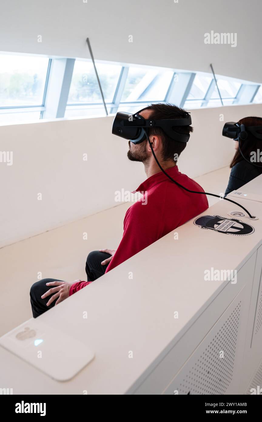 Visitors trying virtual reality glasses at Mobility City Technology ...
