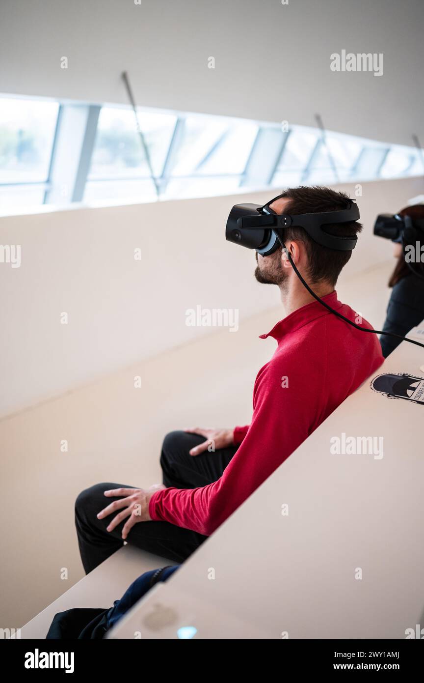 Visitors trying virtual reality glasses at Mobility City Technology ...