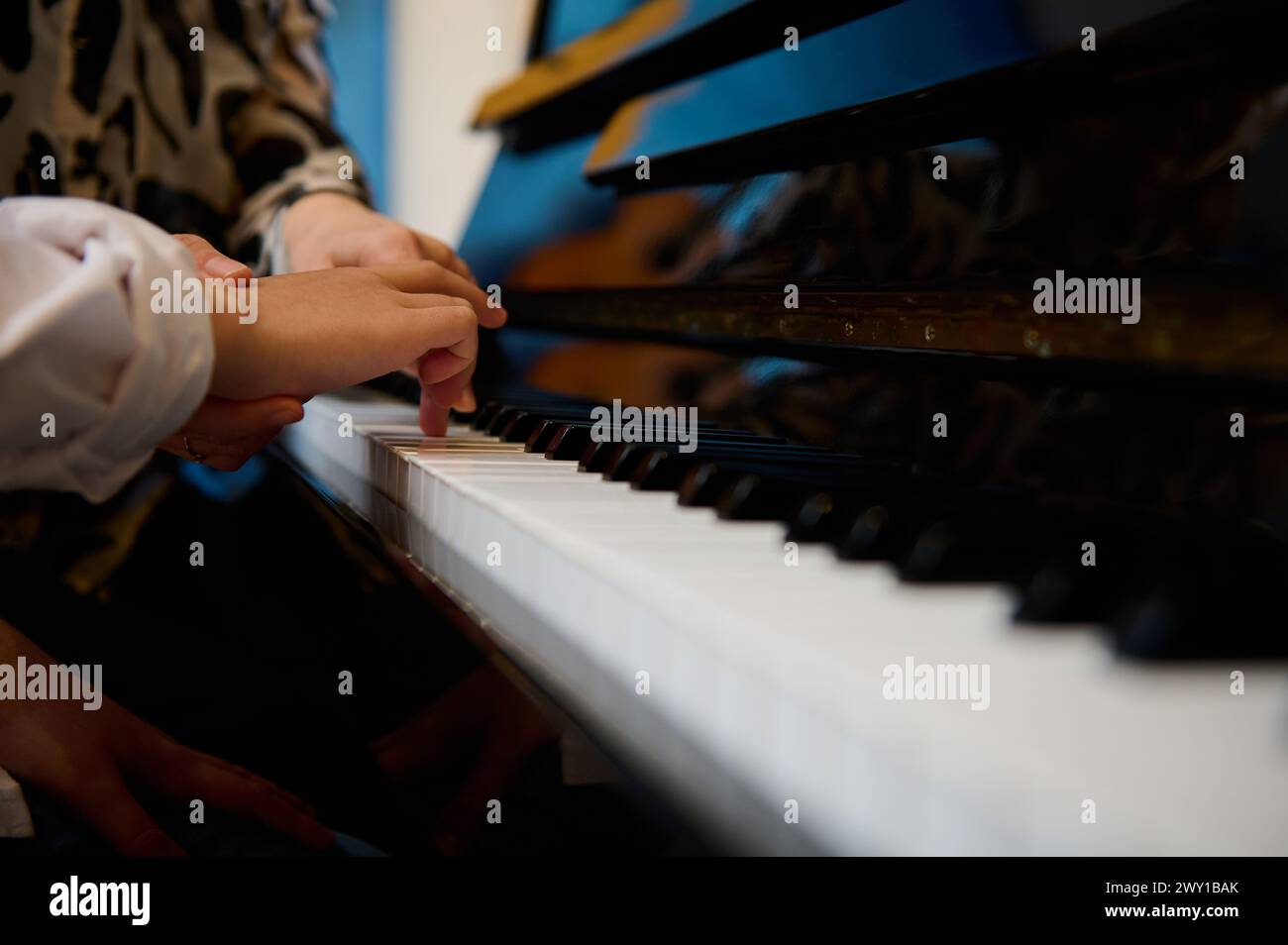 Side view hands of musician pianist teacher maestro teaching a child ...