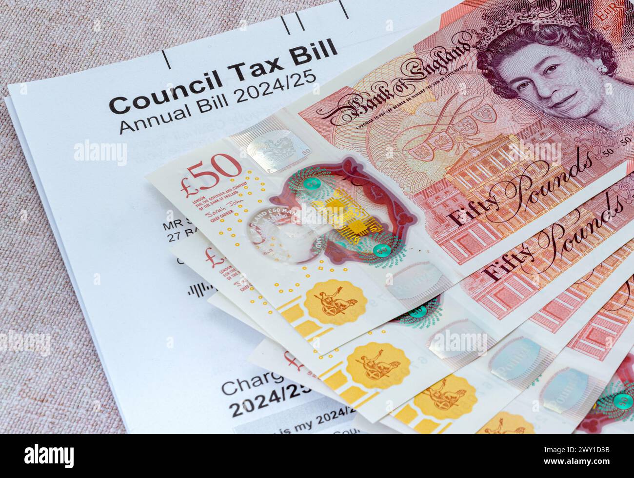 UK Council Tax Bill for 2024/25 with fifty pound notes Stock Photo - Alamy