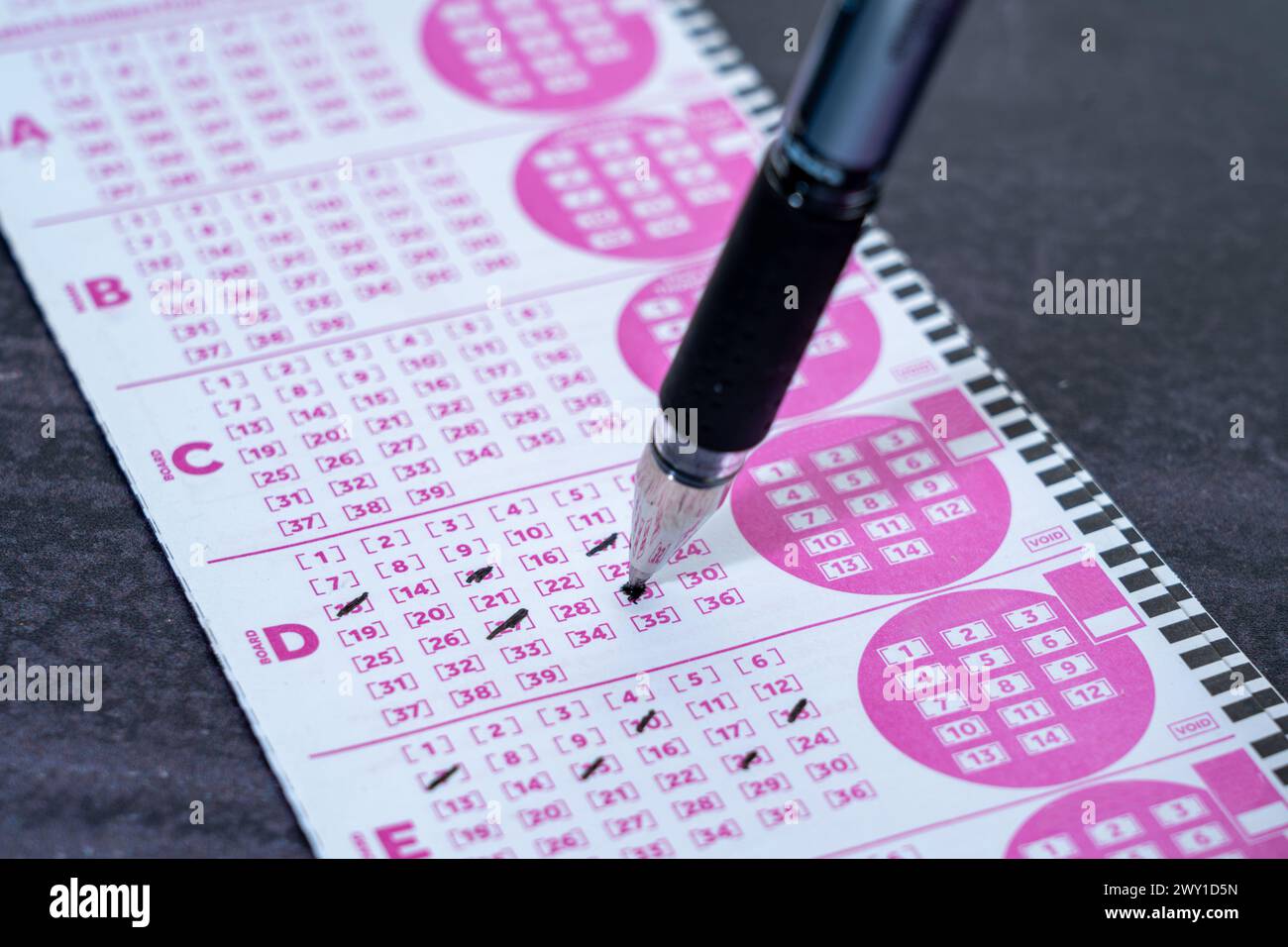 Selecting numbers on a lottery ticket Stock Photo - Alamy