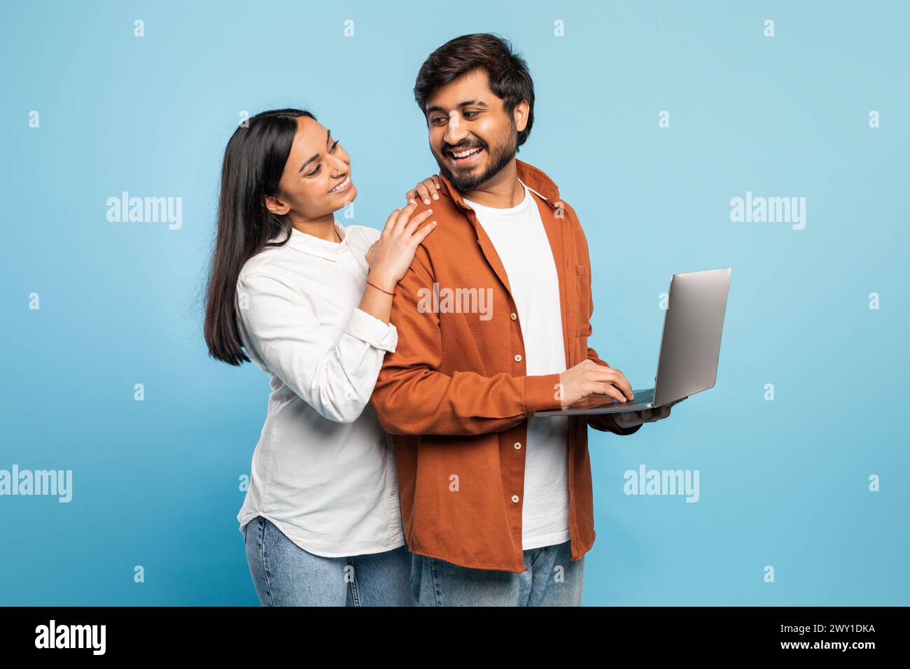 Two people browsing on a laptop together Stock Photo - Alamy