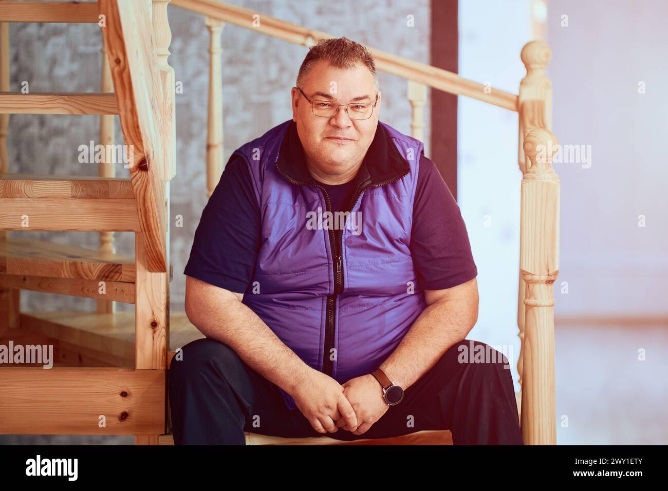 Slight smile on lips of Caucasian man of large build, in his 40s ...