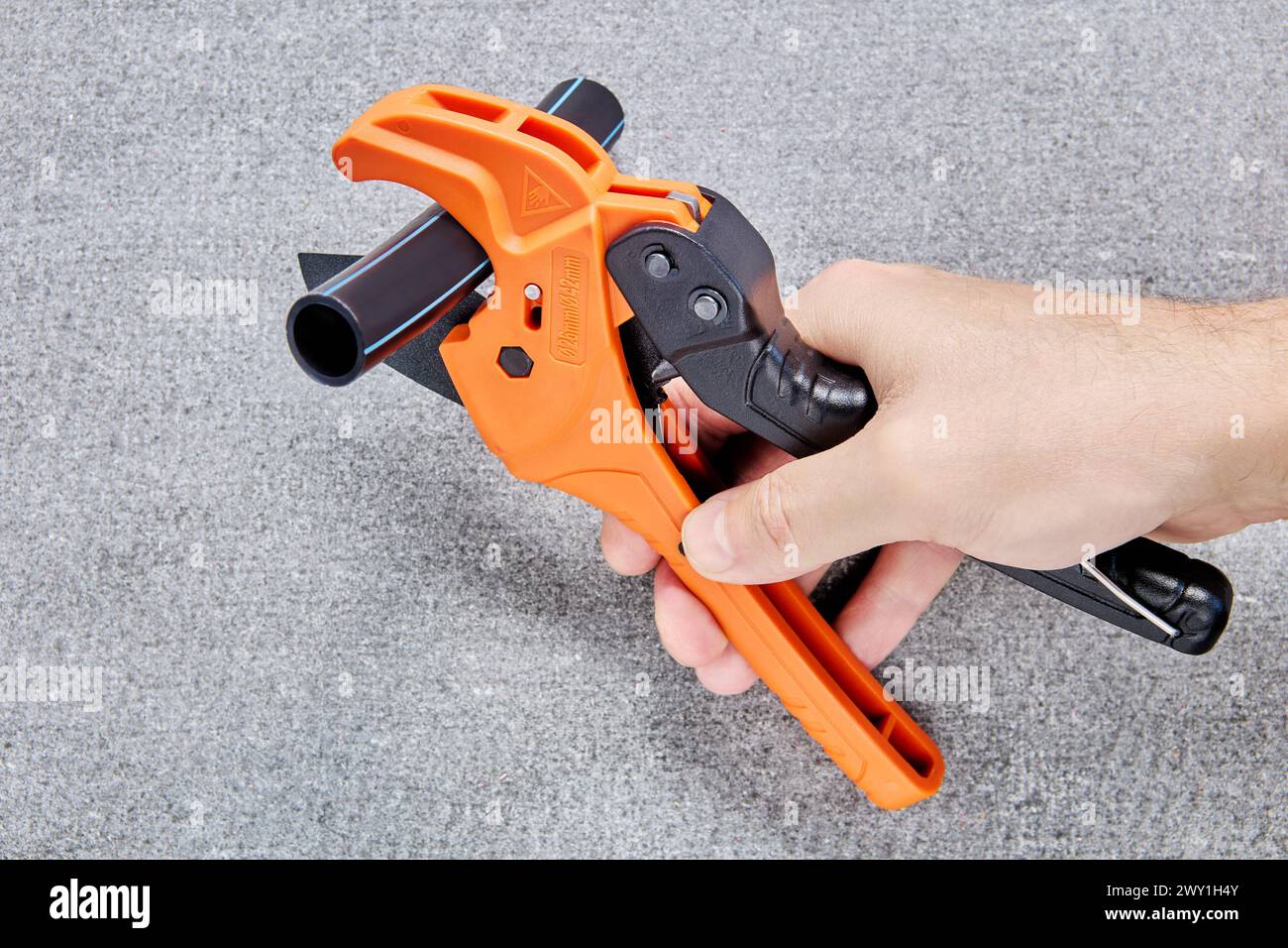 Ratcheting pipe cutter in shape of scissors with polyethylene tube on ...