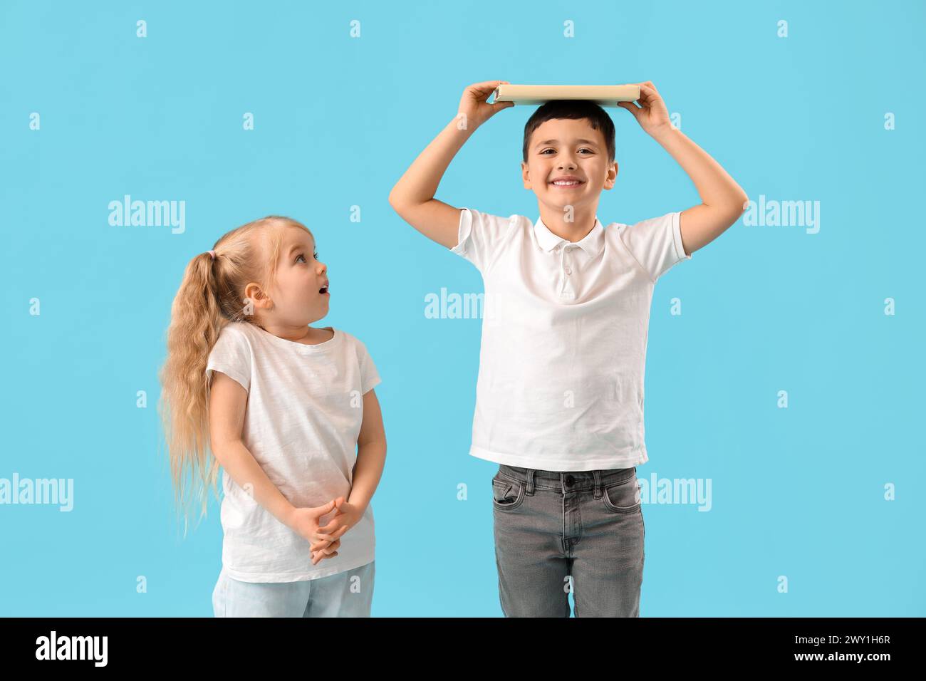 Cute little kids measuring height on blue background Stock Photo - Alamy