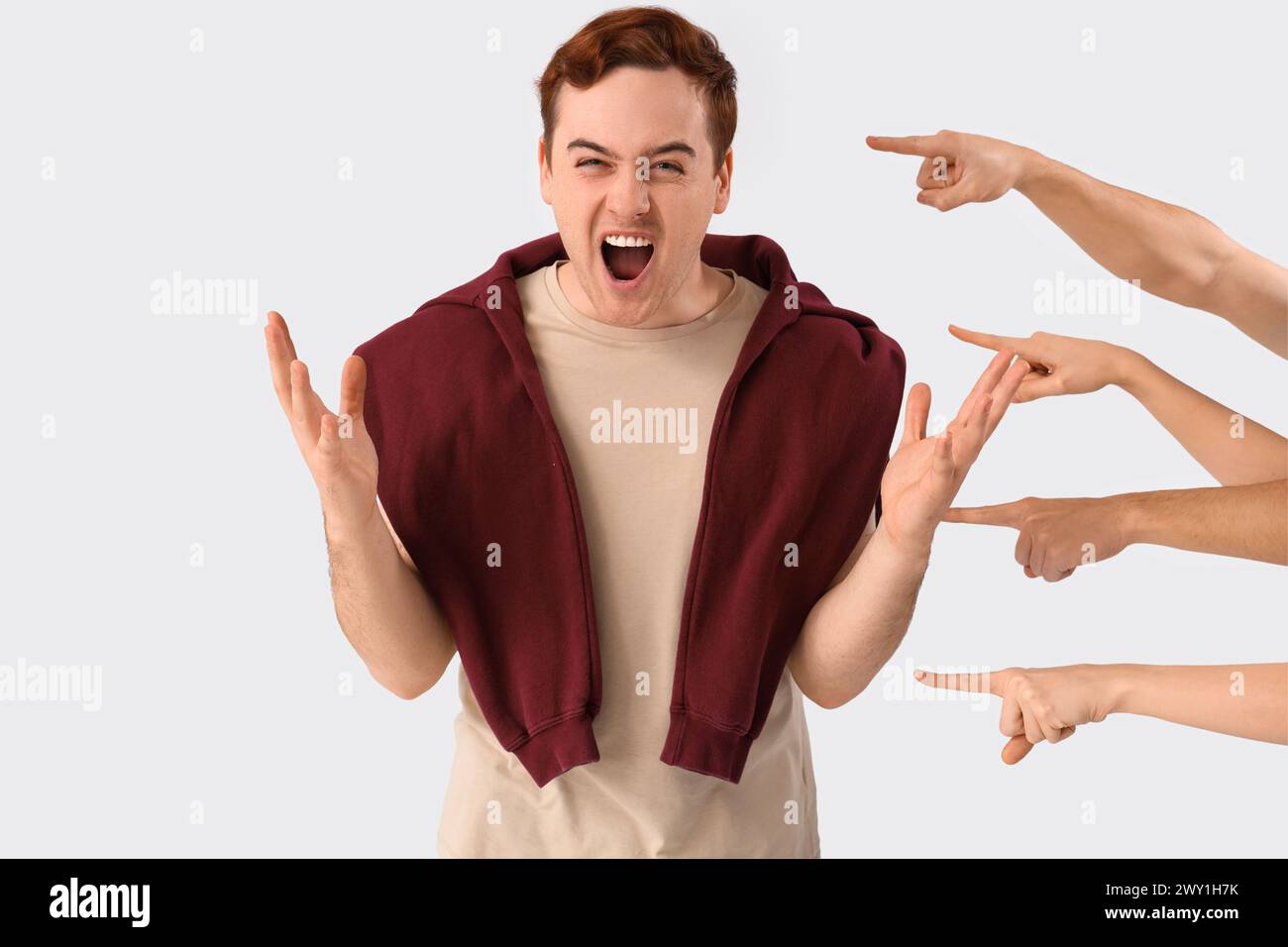 People pointing at angry young man on white background. Accusation ...