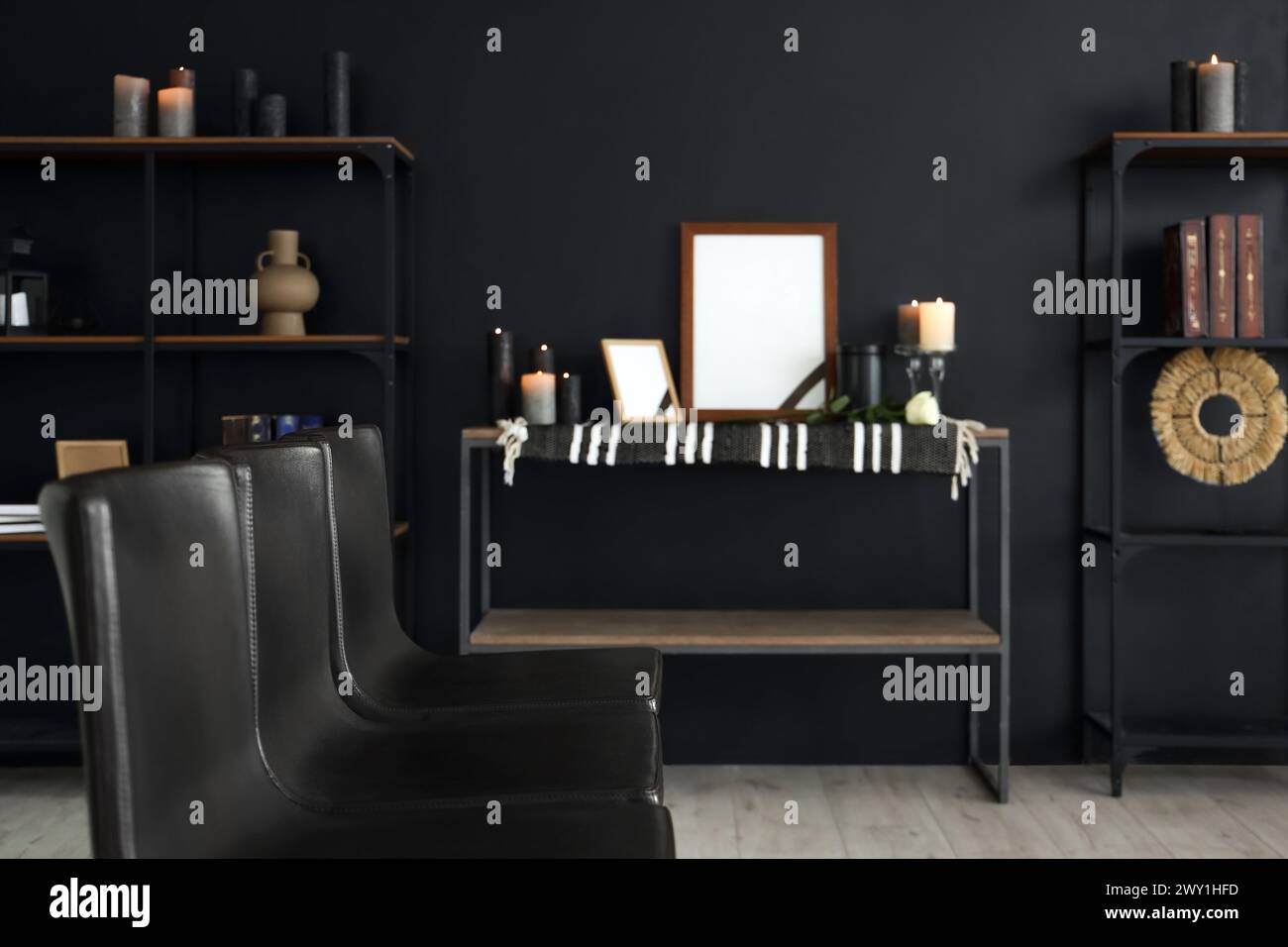 Interior of dark room with chairs and mortuary urn on shelf Stock Photo ...