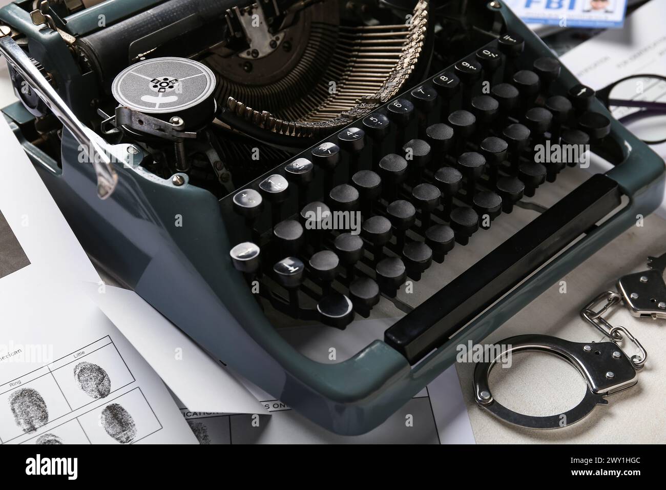 Retro typewriter, handcuffs and criminal files, closeup Stock Photo - Alamy